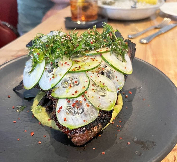 Thinly sliced apple adds brightness to this perfectly prepared fish &ndash; a testament to the kitchen's commitment to balancing flavors and textures.