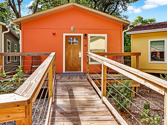 Vibrant exterior colors pop against the green landscape, making each cottage a cheerful beacon among the ancient oak trees.