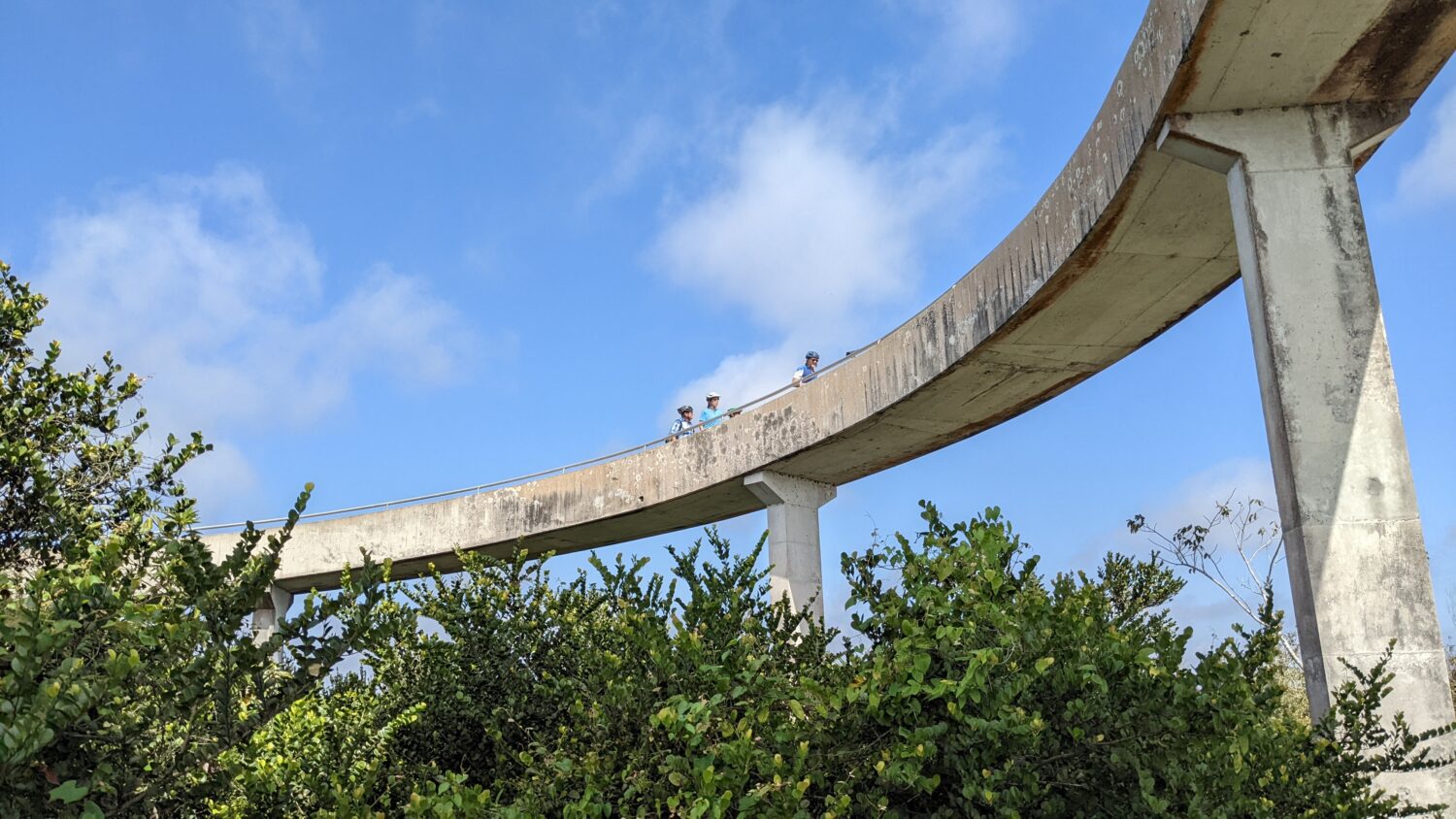 A different view of the tower with people hiking