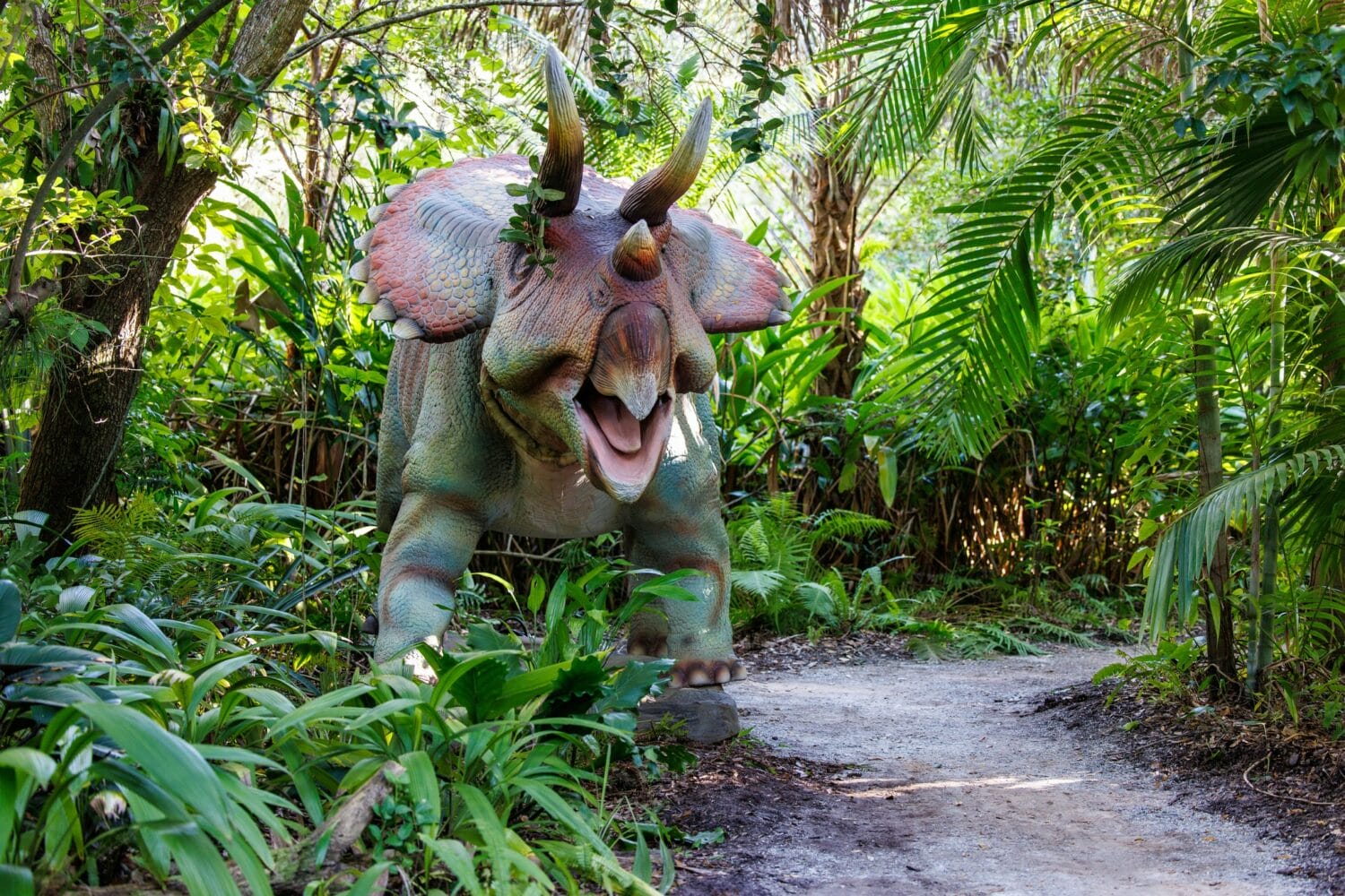 A dino statue within the garden