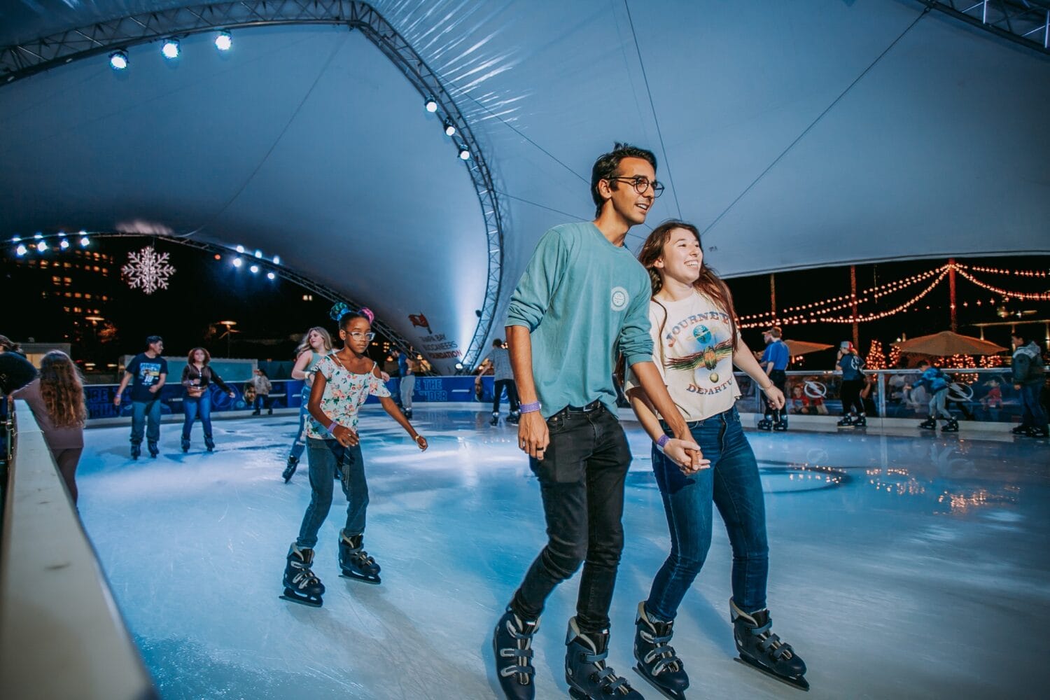 A group of happy people ice skating