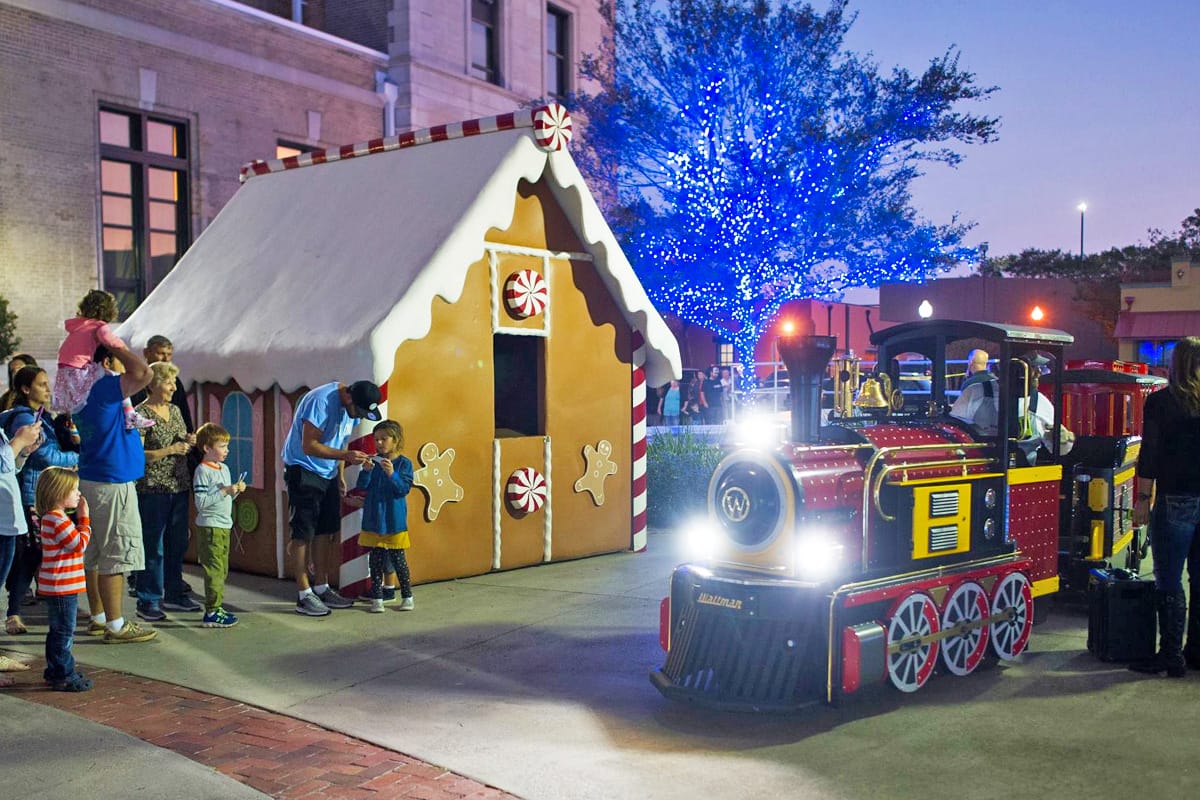 A holiday trolley with Christmas decorations in the background