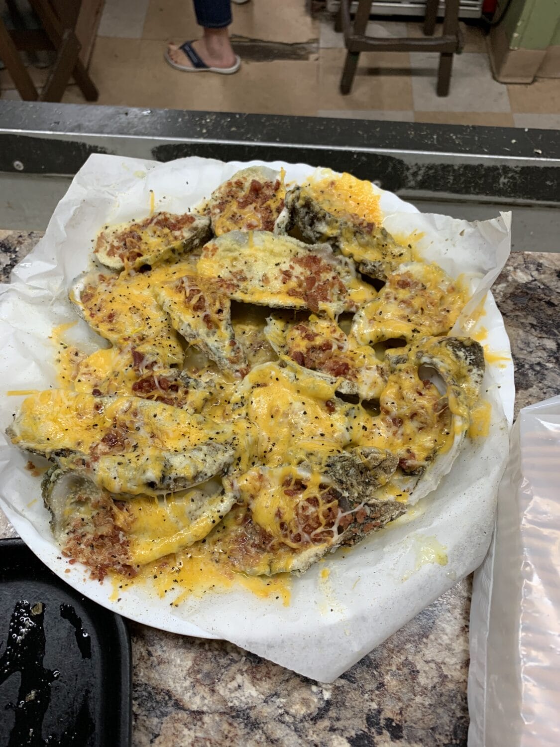 A plate of cheesy baked oysters.