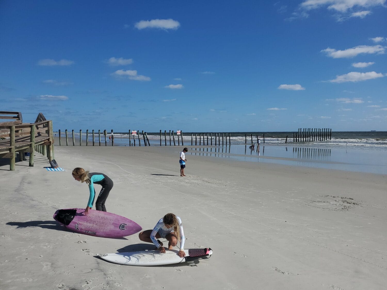 A shot of surfers getting ready to hit the waves.