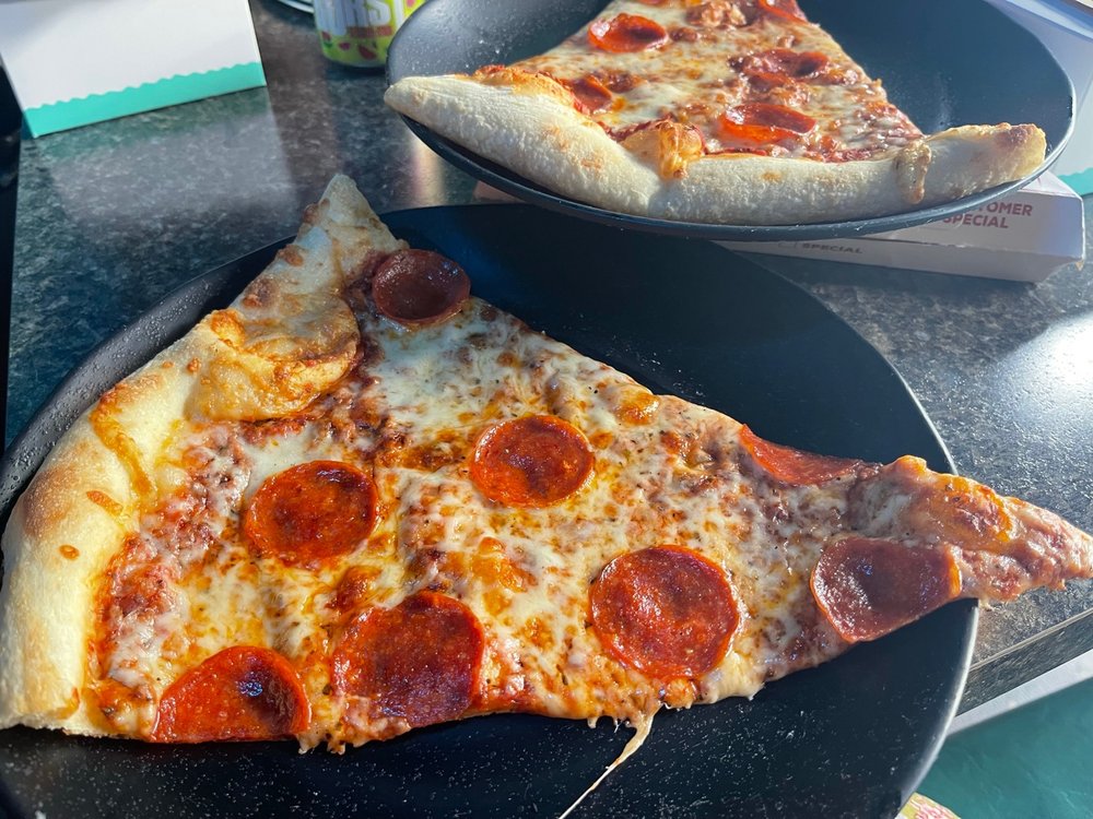 A slice of loaded pizza.