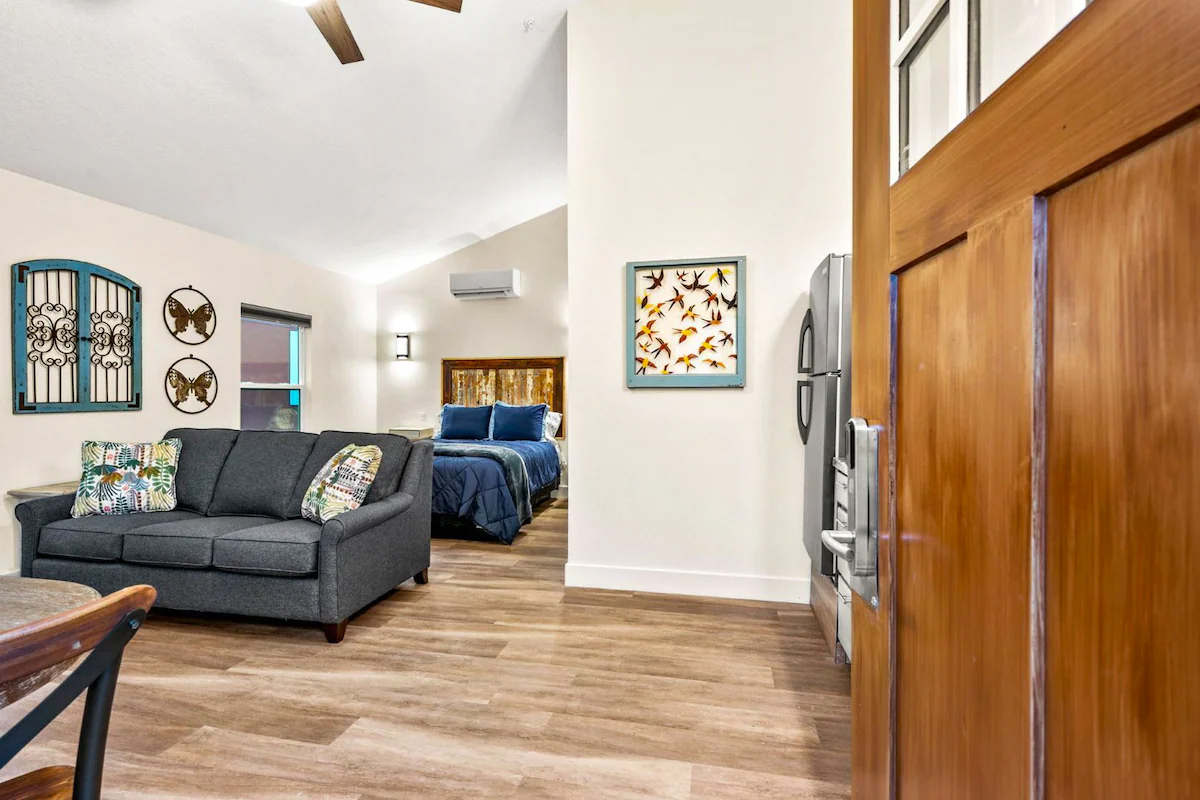 A view of the inside with the bed and a couch.