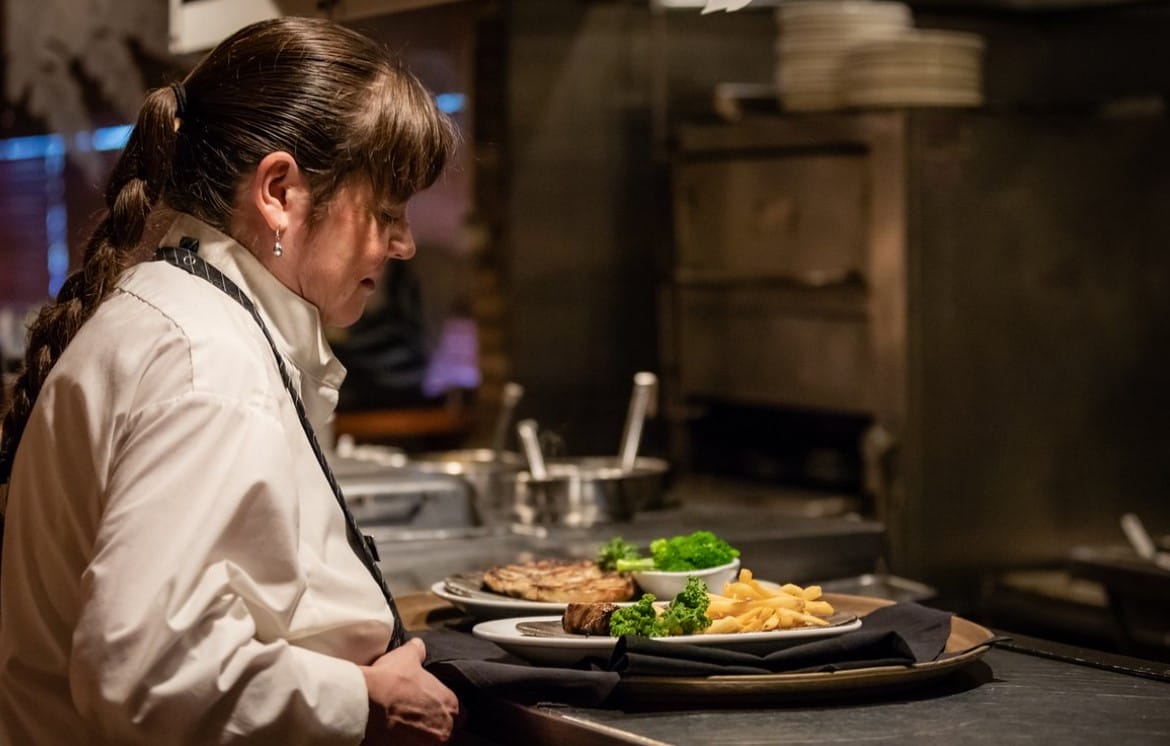 a waitress preparing a meal