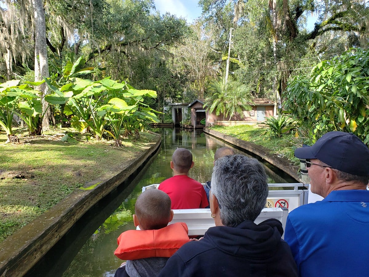 People in a boat ride passing through a beautiful sight
