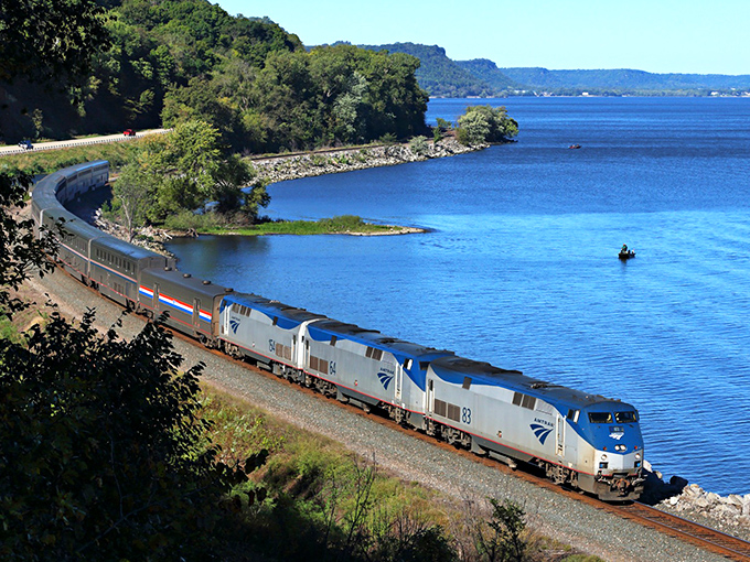 Amtrak's Empire Builder glides along the Mississippi River, offering passengers front-row seats to nature's grandest show without a single traffic jam.