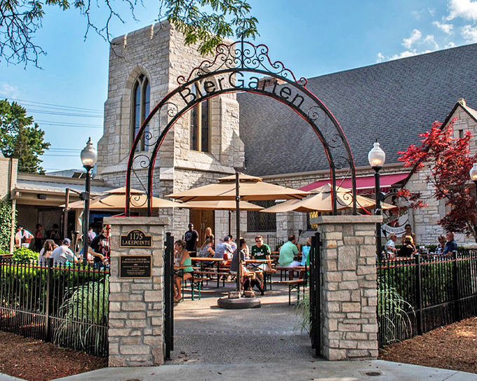 The iconic wrought-iron "Biergarten" arch welcomes visitors to Atwater in the Park, where sacred stone architecture meets culinary delight in Grosse Pointe Park.