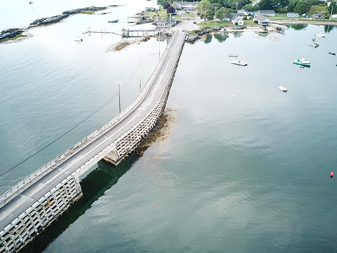 Aerial view of the Cribstone Bridge stretching across the water like a granite ribbon connecting island communities.