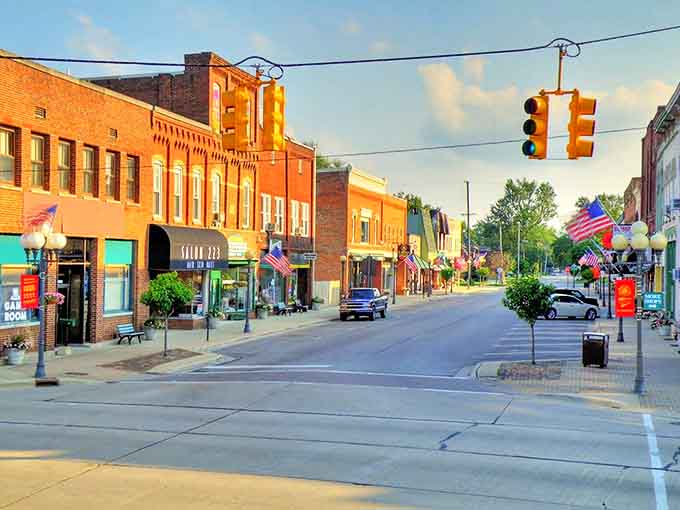 Blissfield's main street glows with golden hour light, brick buildings standing proud like sentinels of small-town American charm.
