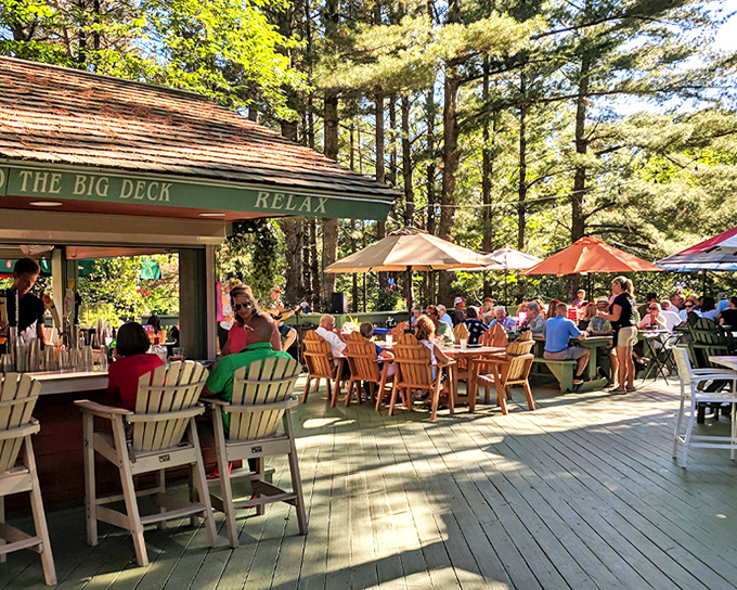 The forest parts to reveal Boone's Long Lake Inn, where culinary magic happens beneath towering Michigan pines.