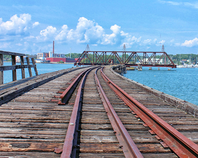 The East End Rail Bridge stretches across Portland's Back Cove like an industrial fossil, its rusted framework a testament to Maine's railroad glory days.