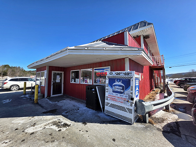 The iconic red building stands proudly against the Vermont landscape, a beacon for hungry travelers seeking more than just fuel.