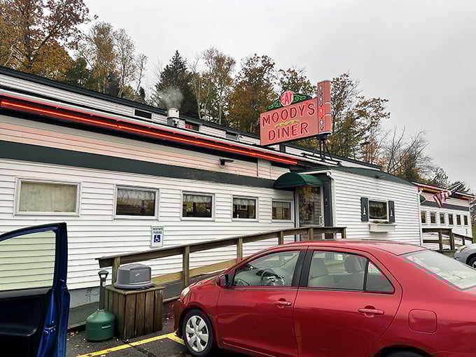 The iconic pink neon sign of Moody's Diner glows like a beacon for hungry travelers along Maine's Route 1, promising comfort food and legendary pie.
