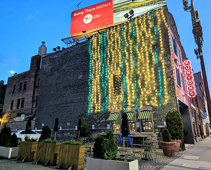Twinkling lights cascade down Runyon's brick facade like a waterfall of stars, promising culinary magic within this Minneapolis landmark.