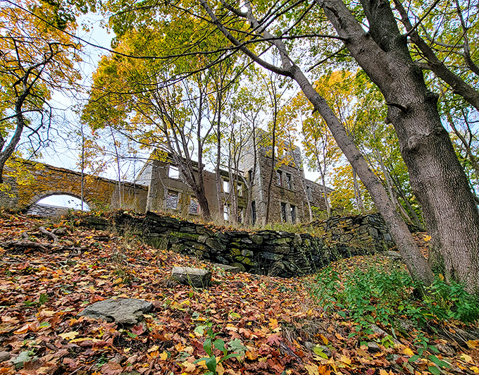 Stone ruins peeking through autumn foliage &ndash; where history and nature embrace in a centuries-old dance at Fort Williams Park.