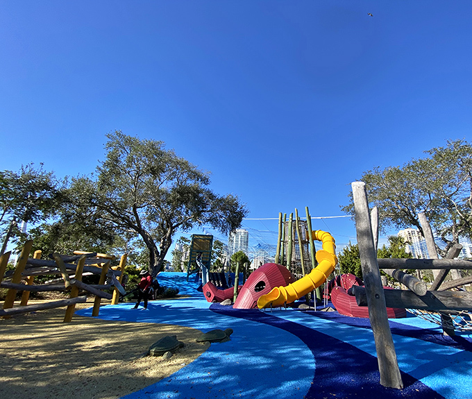 A vibrant blue playground wonderland where marine dreams come to life &ndash; slides and climbing structures beckon young explorers under Florida's perfect sky.
