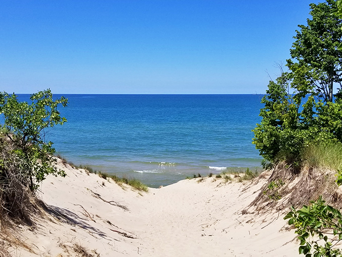 Where sky meets water in perfect harmony, Grand Mere's shoreline promises treasures for those patient enough to search.