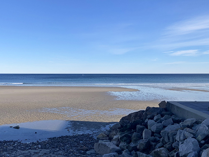 Laudholm Beach stretches out like nature's welcome mat, where golden sands meet the Atlantic's impossible blues.