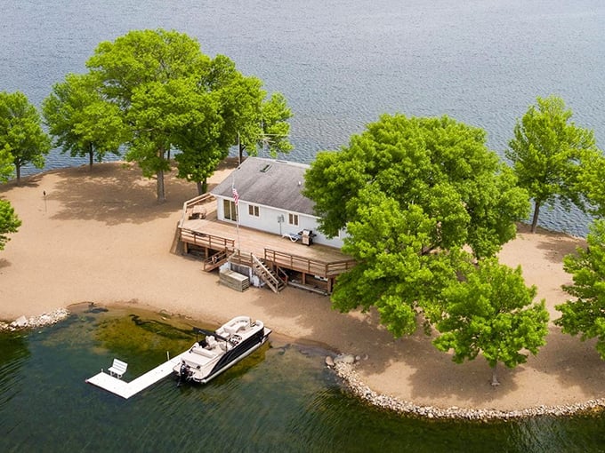 Aerial view of paradise: Lone Tree Island emerges from O'Dowd Lake like a private Eden, complete with sandy shores and verdant trees.