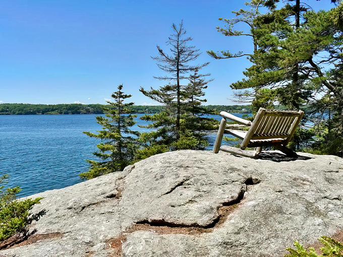 A wooden bench perched on granite overlooking the Sheepscot River &ndash; nature's front-row seat to Maine's coastal symphony.