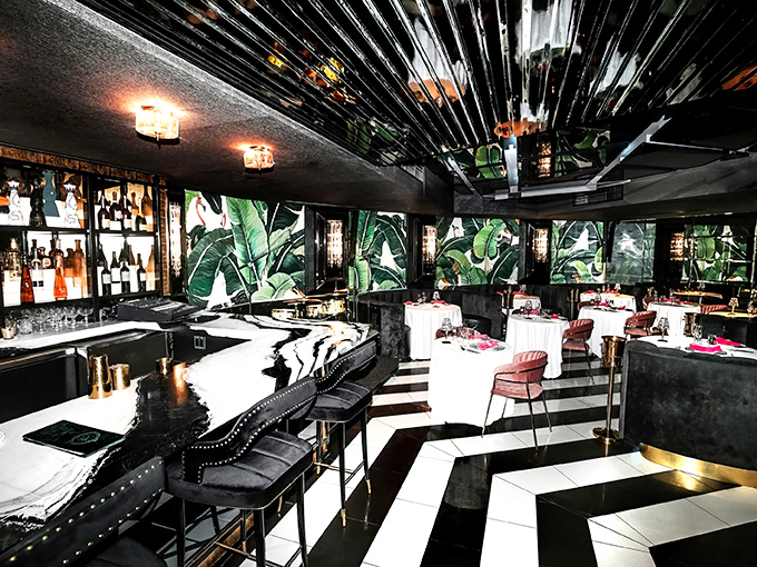Step into a world where banana leaf wallpaper meets mirrored ceilings &ndash; tropical glamour with a side of self-reflection.