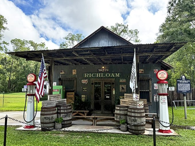 The Richloam General Store stands proudly in Webster, Florida, its weathered tin exterior and vintage gas pumps offering a portal to simpler times.