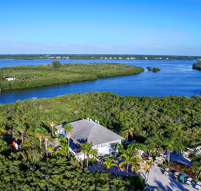 Rum Bay Restaurant: A waterfront oasis nestled among palms, where the journey across blue waters is just the beginning of your culinary adventure.