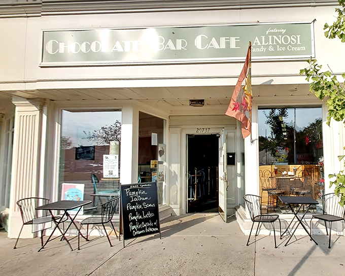 The welcoming storefront of Chocolate Bar Cafe beckons sweet-toothed travelers with its classic charm and promise of sugary treasures within.