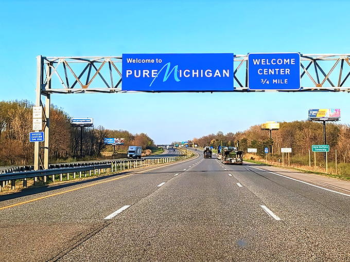 The iconic blue highway sign stands as a proud sentinel, welcoming travelers to the Great Lakes State with its distinctive cursive "M."