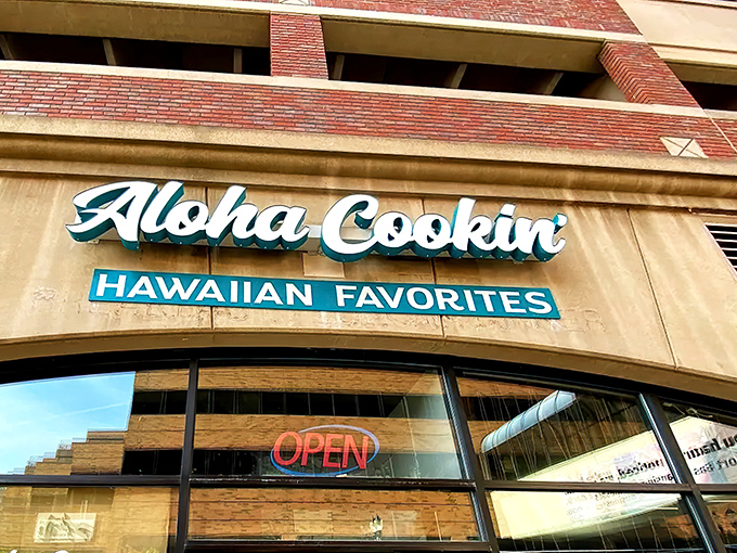 The welcoming facade of Aloha Cookin' stands out on Rockbridge Road, promising a Hawaiian escape with its vibrant turquoise signage and inviting entrance.