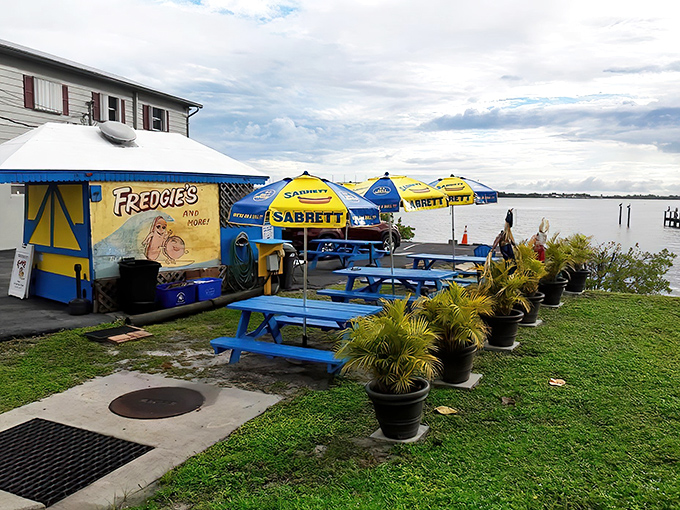 Exterior: Fredgie's blue and yellow stand beckons like a tropical mirage, promising waterfront bliss and hot dog perfection on Jensen Beach's shoreline.