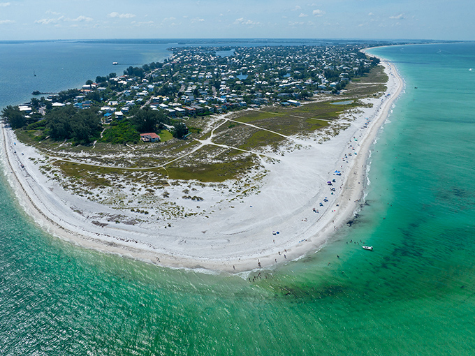 Anna Maria Island's pristine coastline curves gracefully between Gulf and bay waters, a paradise peninsula waiting to be explored.