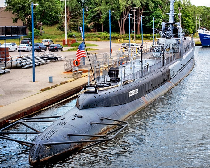 The USS Silversides rests majestically at its Muskegon dock, its sleek black hull a stark reminder of America's underwater warriors during WWII.