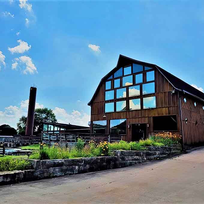 Sunlight dances across The Barn's impressive wooden facade, where rustic architecture meets culinary excellence in a postcard-perfect Wisconsin setting.