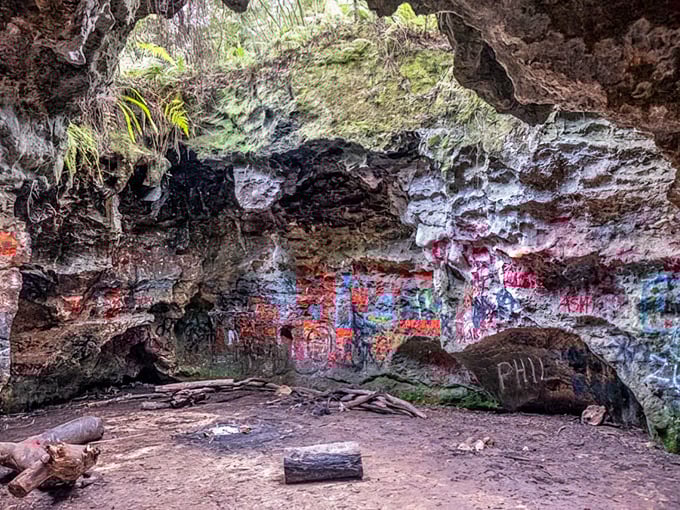 Nature's art gallery comes complete with graffiti! This cave chamber showcases years of colorful visitor contributions alongside natural limestone formations.