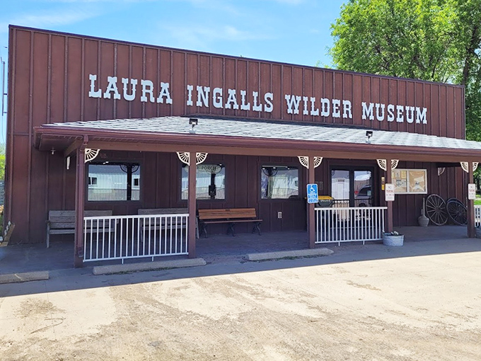 The rustic red exterior welcomes visitors like an old friend, promising stories and adventures from a bygone era just beyond those doors.