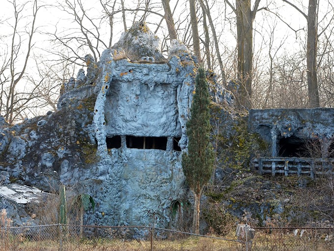 The mysterious blue-gray structures of the abandoned Prehistoric Forest stand as silent sentinels, nature slowly reclaiming what was once a bustling attraction.