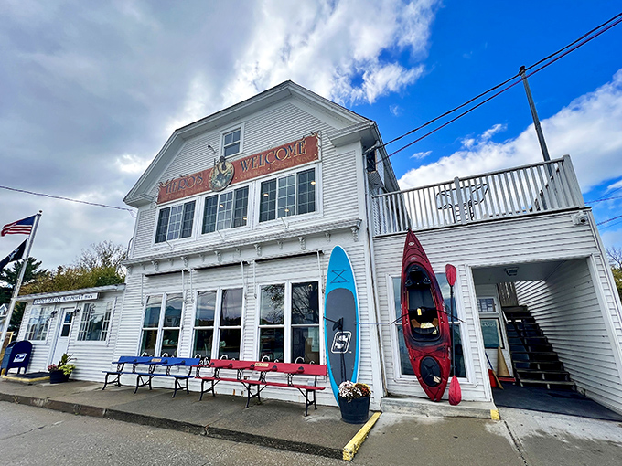Classic New England charm greets visitors at Hero's Welcome, where kayaks and a welcoming porch set the lakeside scene.