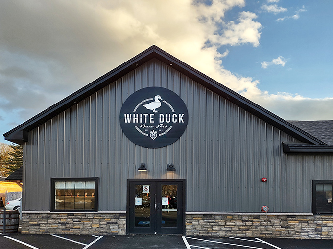 The White Duck Pub's barn-inspired exterior stands proudly in Winthrop, its gray siding and stone foundation promising rustic elegance before you even step inside.