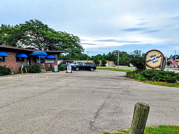 The What Not Inn welcomes you with honest brick walls and cheerful blue awnings that promise good things inside.