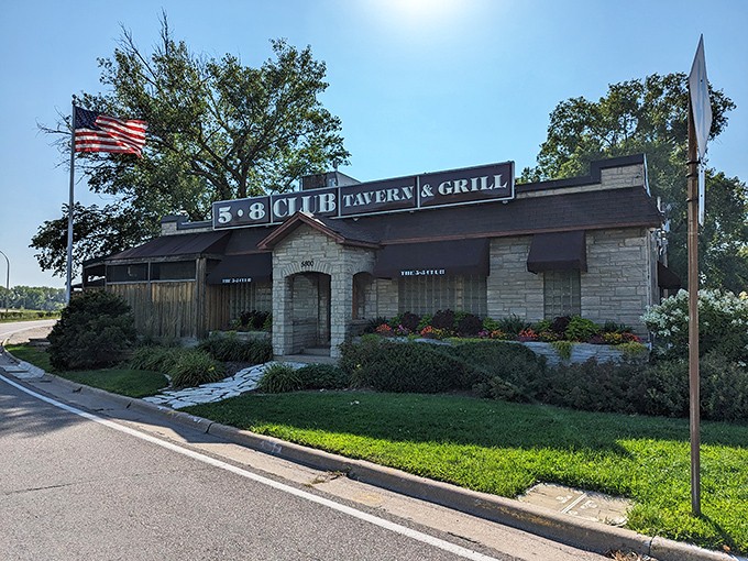 The stone facade of the 5-8 Club stands proudly on Cedar Avenue, an unassuming temple to the burger gods that forever changed how we think about cheese placement.