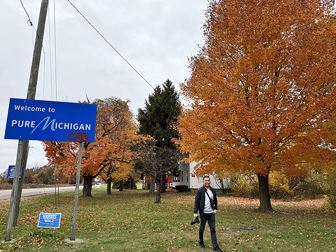 Autumn's golden display creates the perfect backdrop for capturing that "I've arrived" moment beneath Michigan's welcoming blue banner.