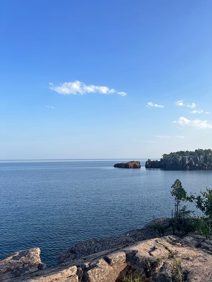 Blue skies and calm waters showcase the beach at its most peaceful, the kind of day that makes you want to cancel all your plans and just stay put.