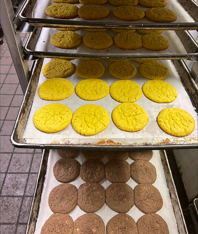 Cookie trays stacked with golden promises &ndash; each rack a different chapter in the delicious story this bakery tells every single day.
