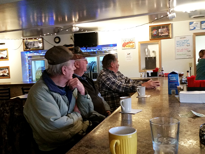 Regular patrons line the bar, swapping stories and savoring hot coffee, the backbone of any true small-town gathering place.