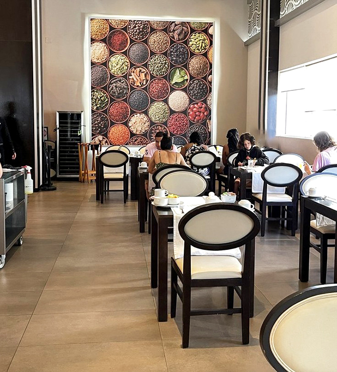 The spice-themed wall art isn't just decoration – it's foreshadowing the flavor explosion happening on plates throughout the dining room.