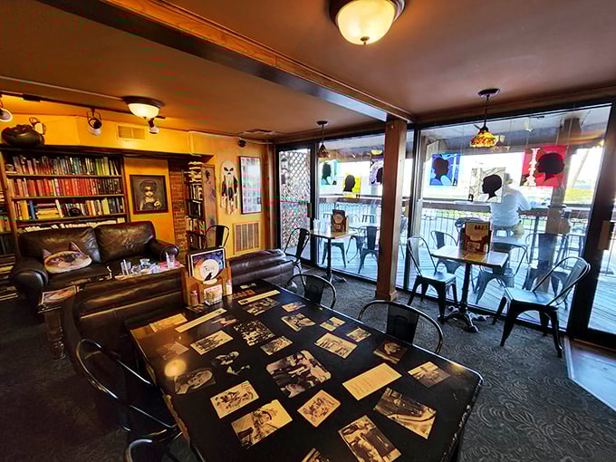 The dining area blends vintage charm with literary coziness – note the table's collage of historic photos beneath glass. Every seat tells a story.
